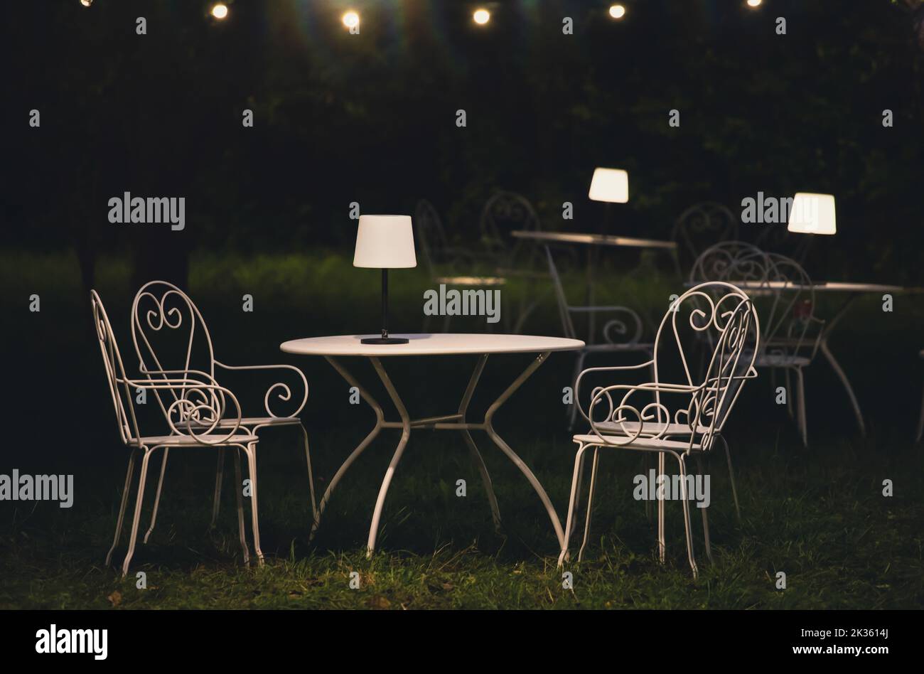 Victorian style cafe with white empty metal chairs and tables in ...