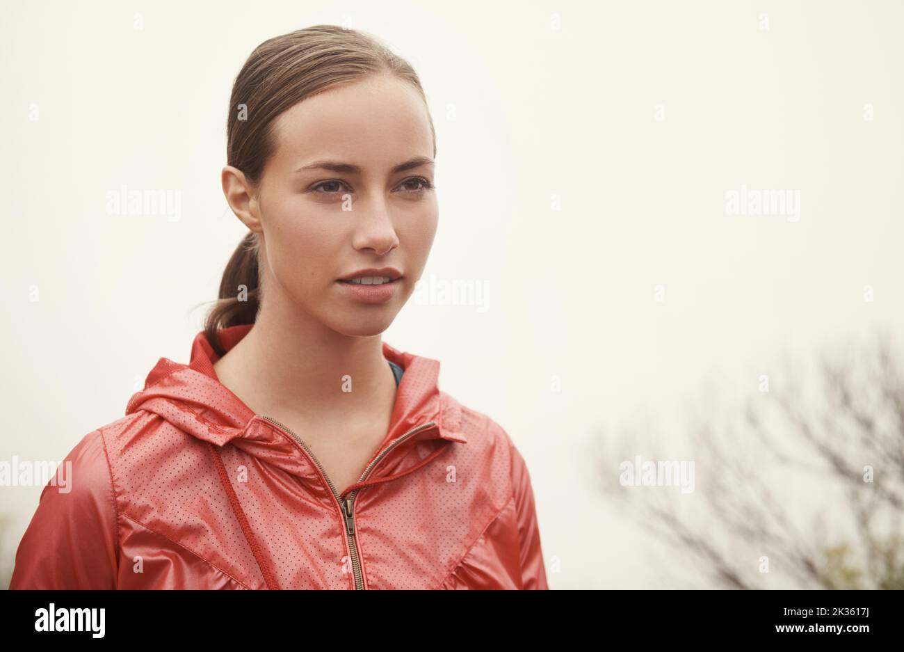 Taking her run one step at a time. a focused young woman out for a run ...