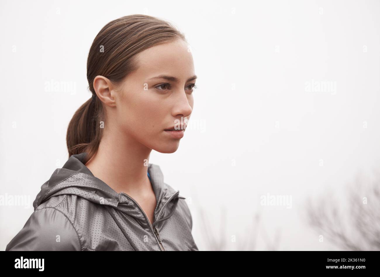 Taking her run one step at a time. a focused young woman out for a run ...