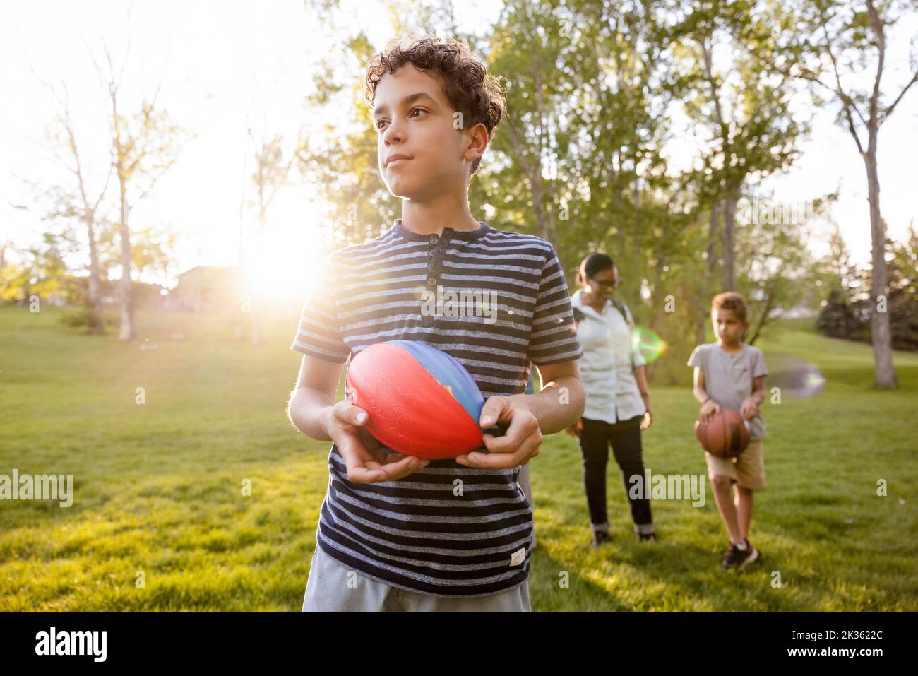 Child carrying ball hi-res stock photography and images - Alamy