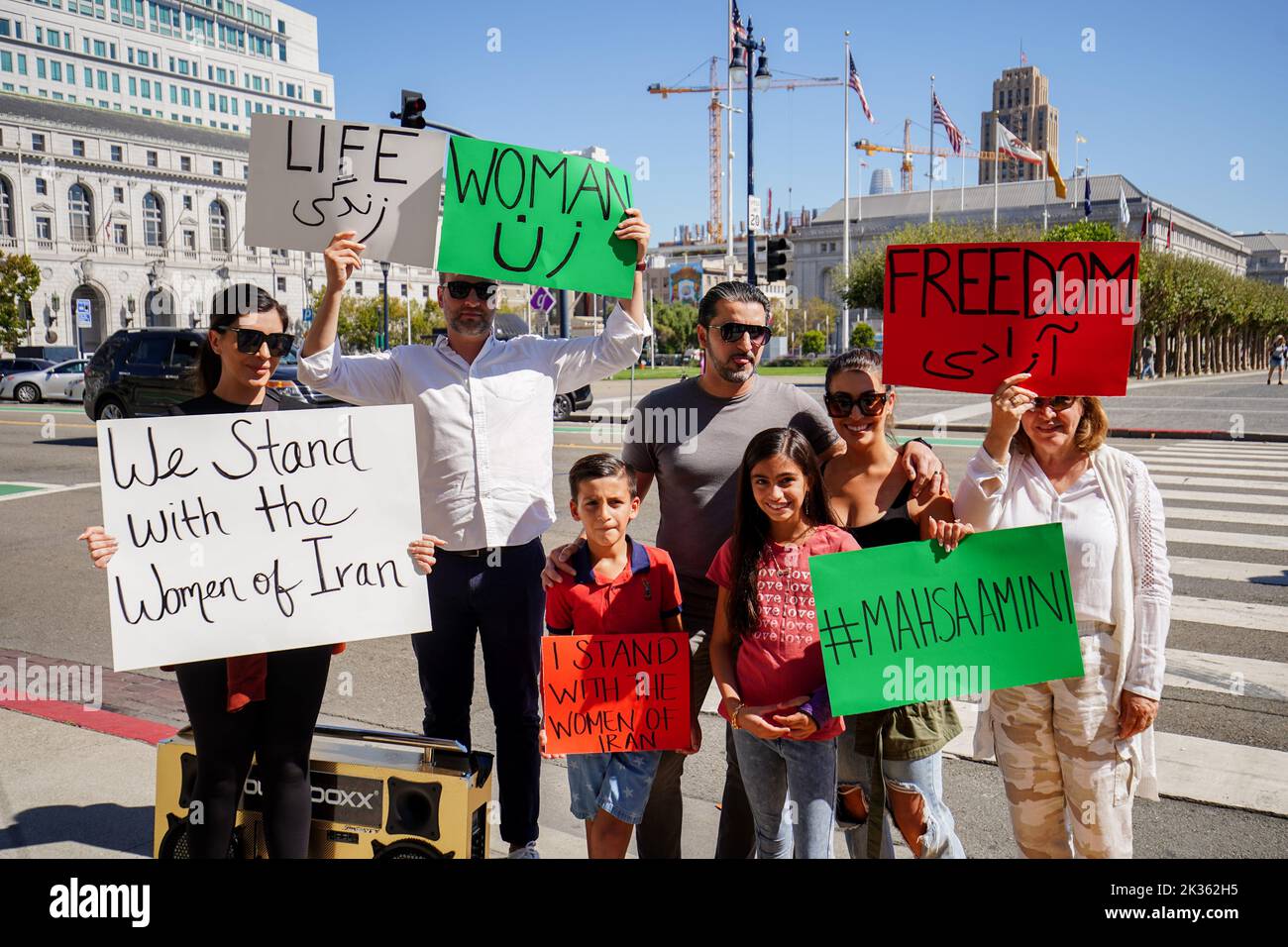 Protesters hold placards in support of Iranian women during the ...