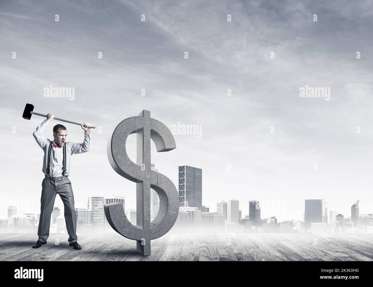 Determined banker man against modern cityscape breaking dollar concrete ...