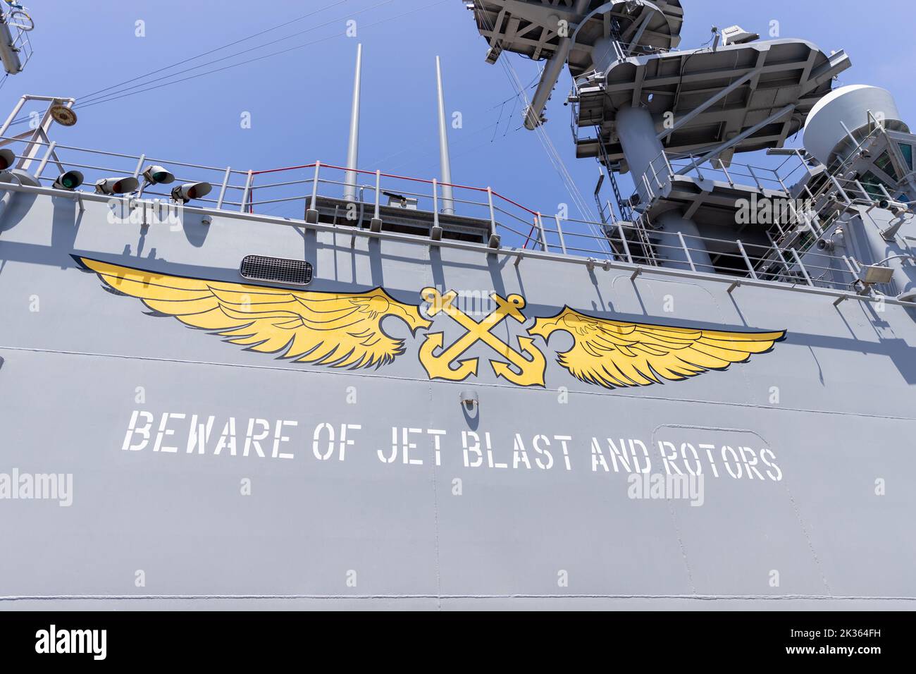 A closeup shot of the beware of jet blast and rotors sign on the deck ...
