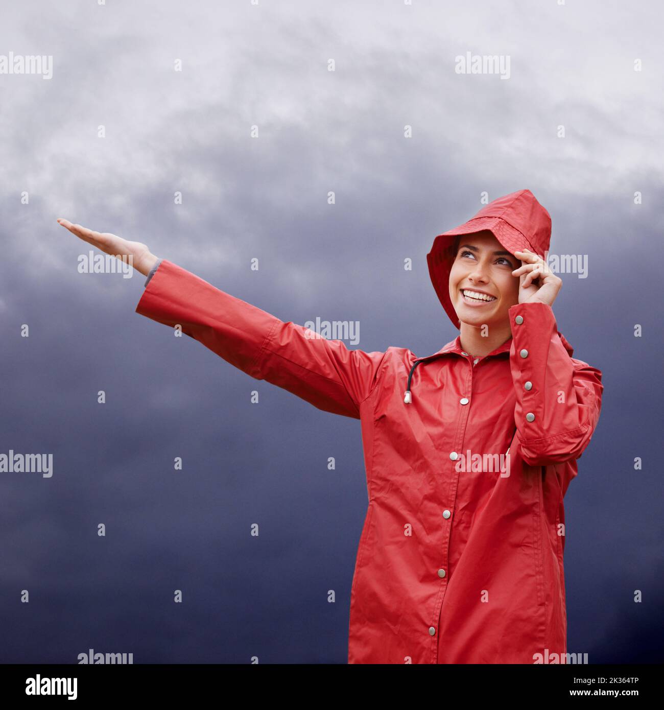 Come rain, come shine..Im ready. an attractive young woman standing in ...