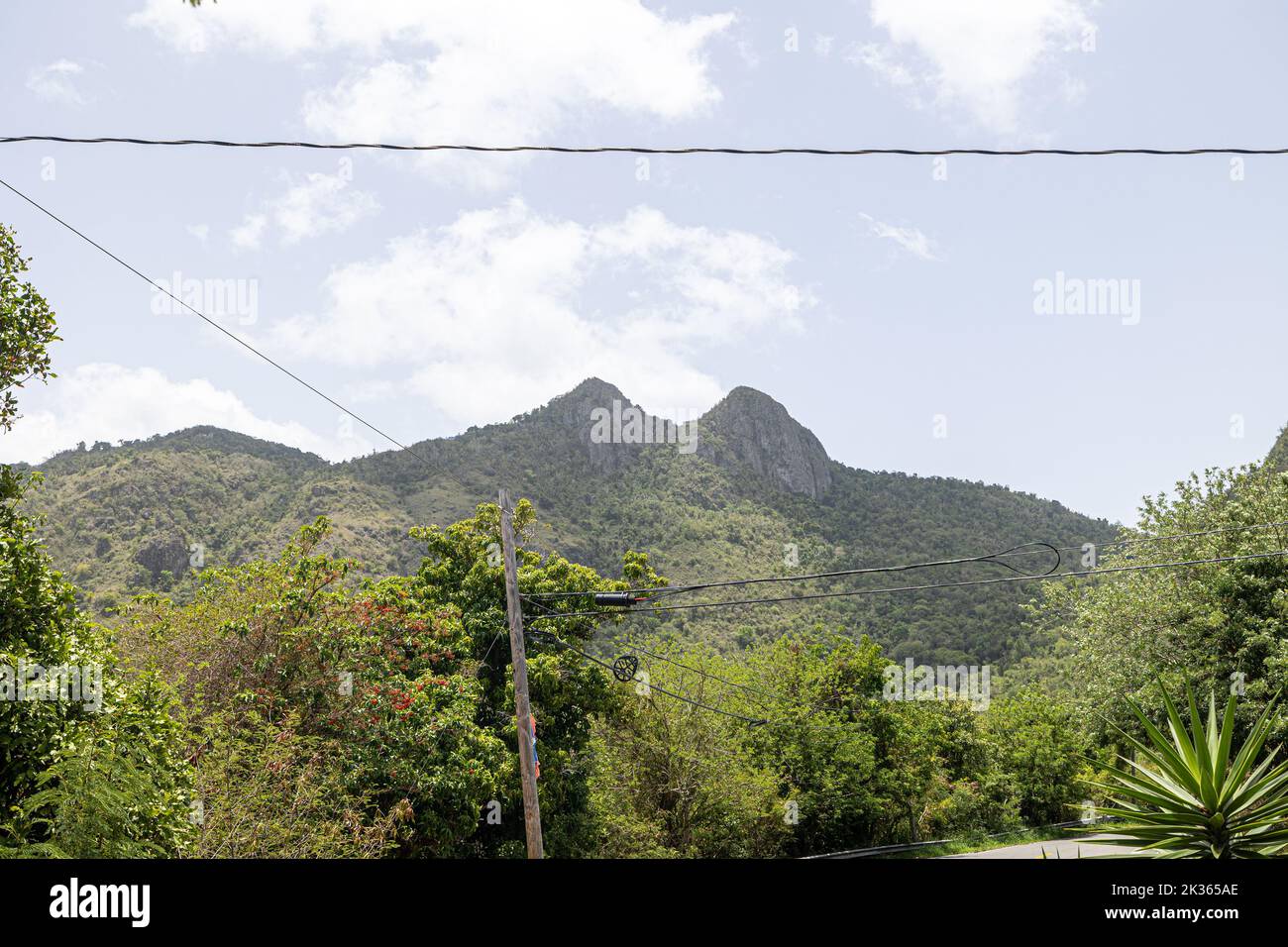 A beautiful view of Cerro Las Tetas peaks under blue cloudy sky in ...