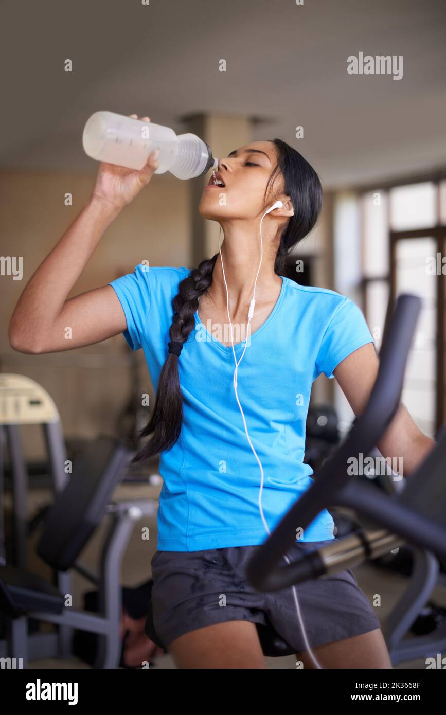 Staying hydrated is important. A teenager on an exercise bike at the ...