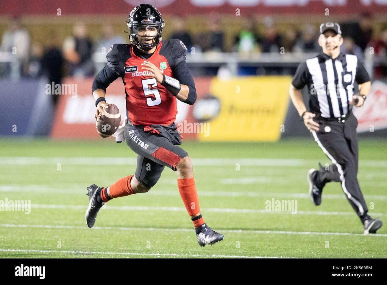 September 24, 2022: Ottawa Redblacks quarterback Caleb Evans (5) runs ...