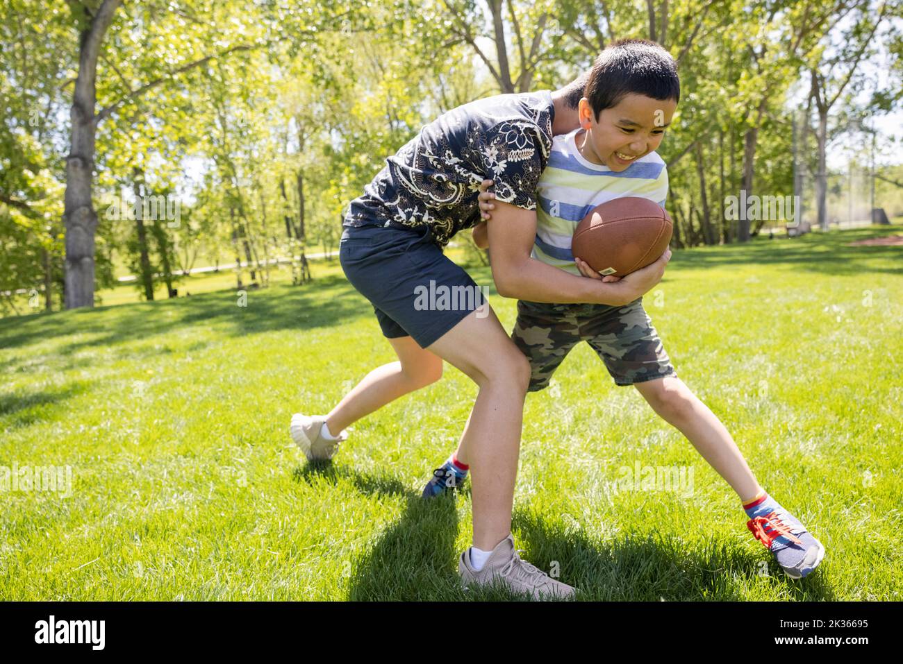 Football at park hi-res stock photography and images - Alamy