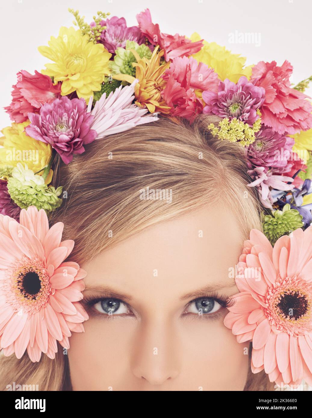 These flowers accentuate her beauty. Portrait of an attractive young woman with beautiful ...