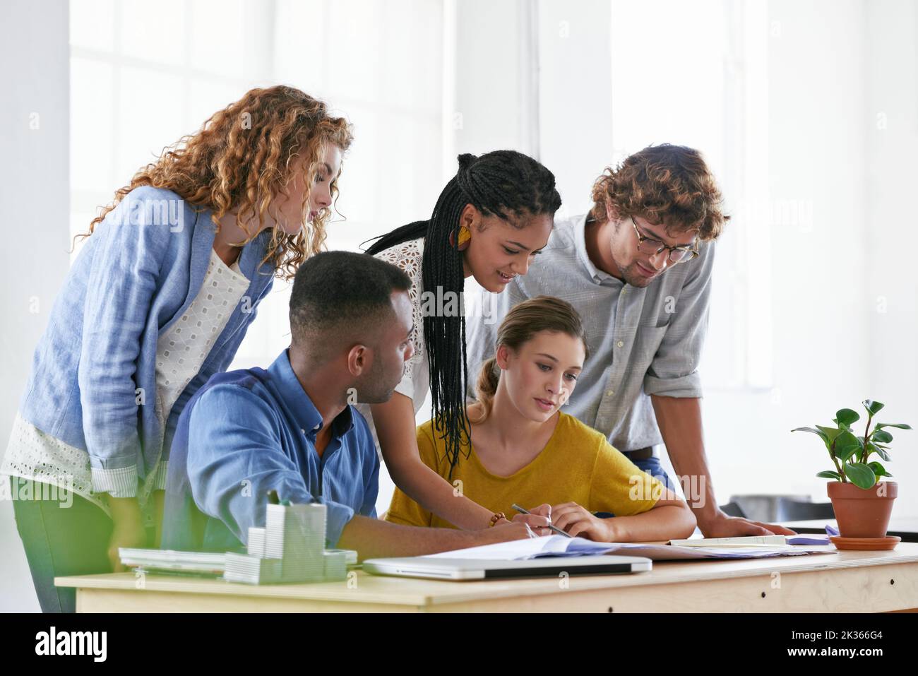 Architects at work. a group of young architects working together on a ...