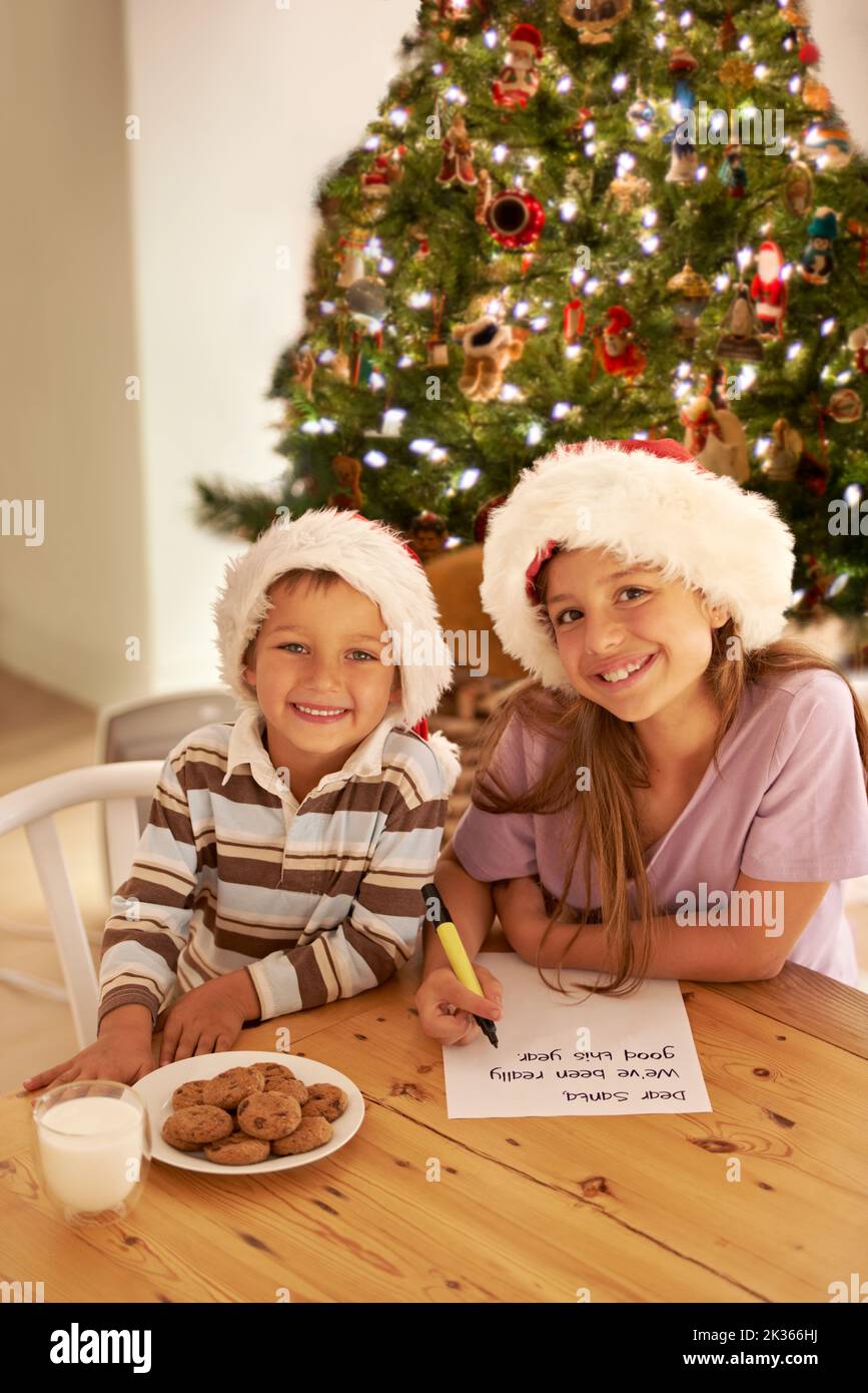 Letters to Santa. Brother and sister writing a letter to Santa and ...