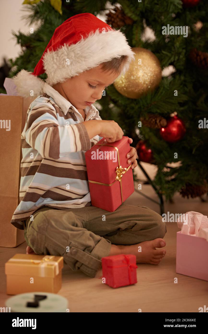 Boy opening gift hi-res stock photography and images - Alamy