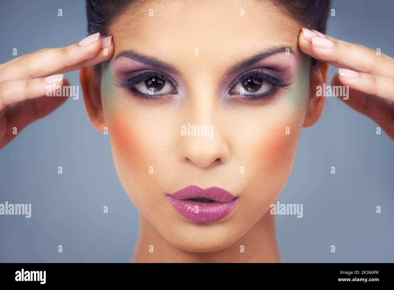 Adventurous Cosmetics. a beautiful young woman covered in makeup Stock ...