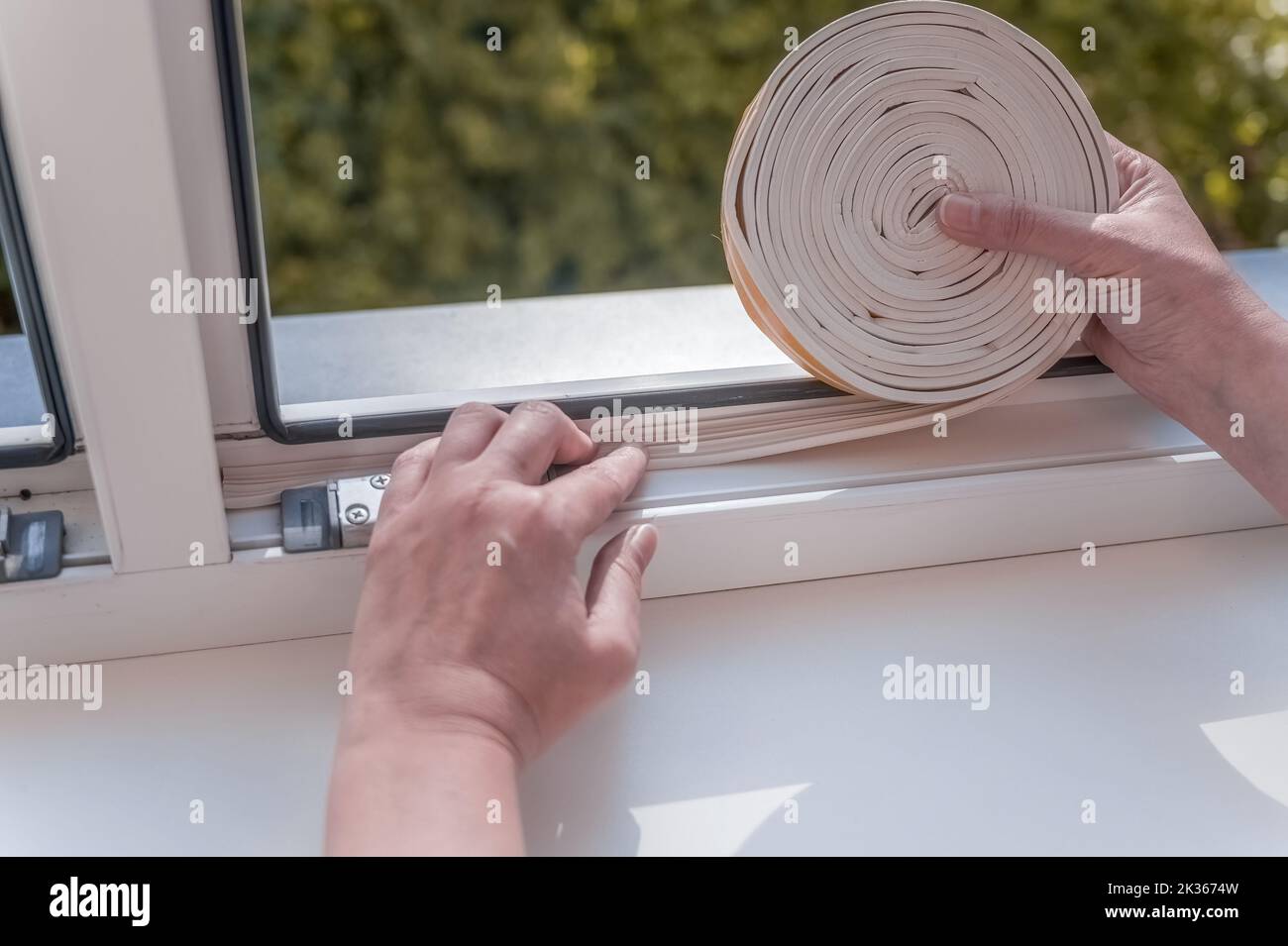 the owner puts sealing tape on the window in the house. Single sided ...