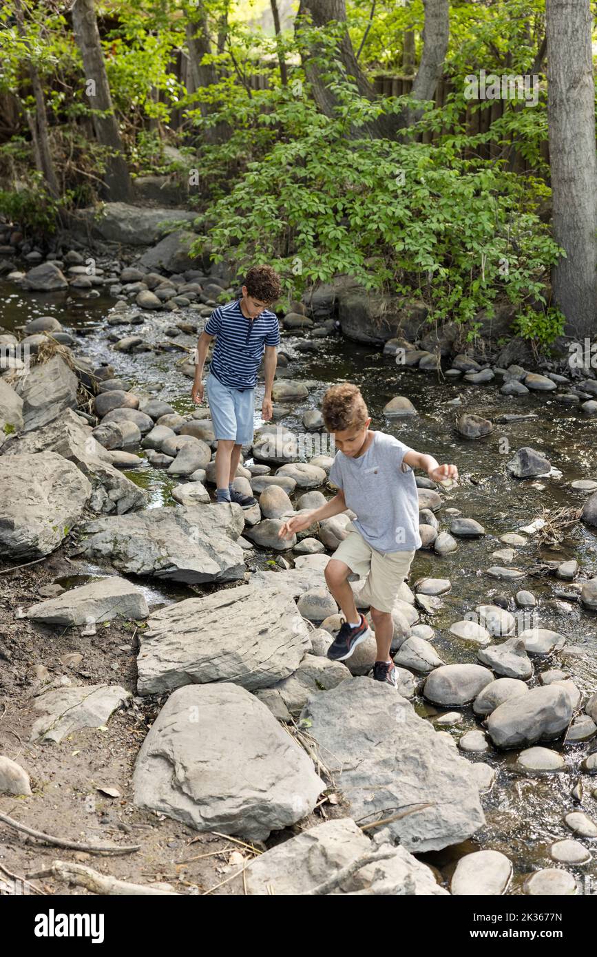 Boy playing in rocks hi-res stock photography and images - Alamy