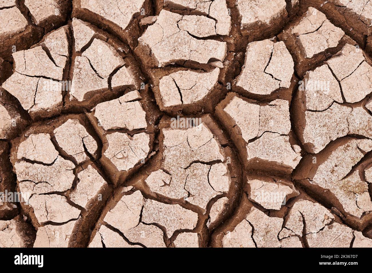 Cracked by the summer heat. Dry cracked ground in the African landscape ...