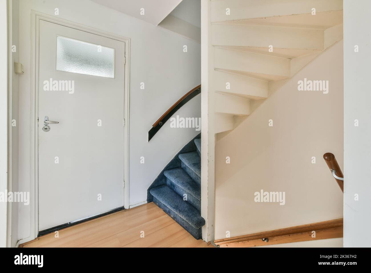 White hallway with stairway leading to second floor of modern luxury ...