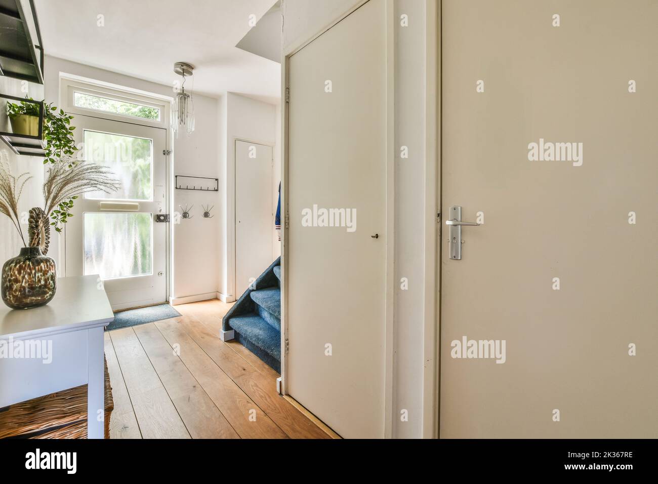 White hallway with stairway leading to second floor of modern luxury ...