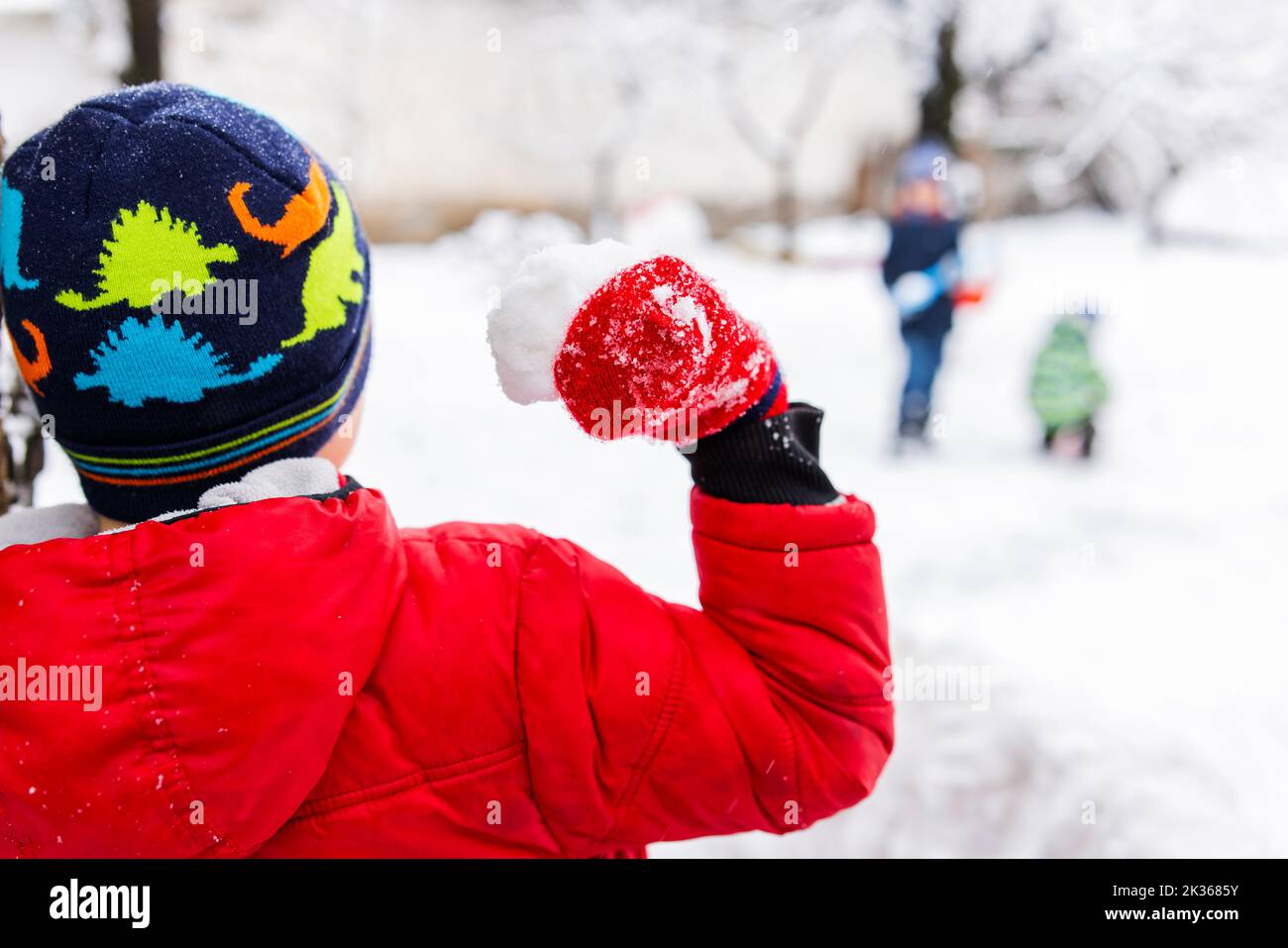 Little children playing with snowballs outdoor in the park Stock Photo ...