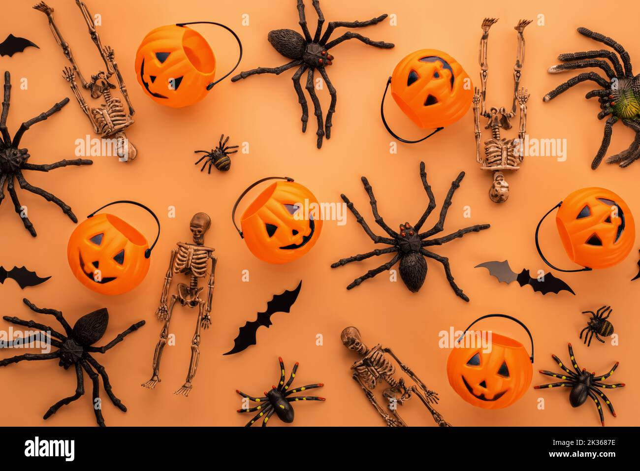 Halloween decorations, pumpkins, skeletons, bats, spiders on orange ...