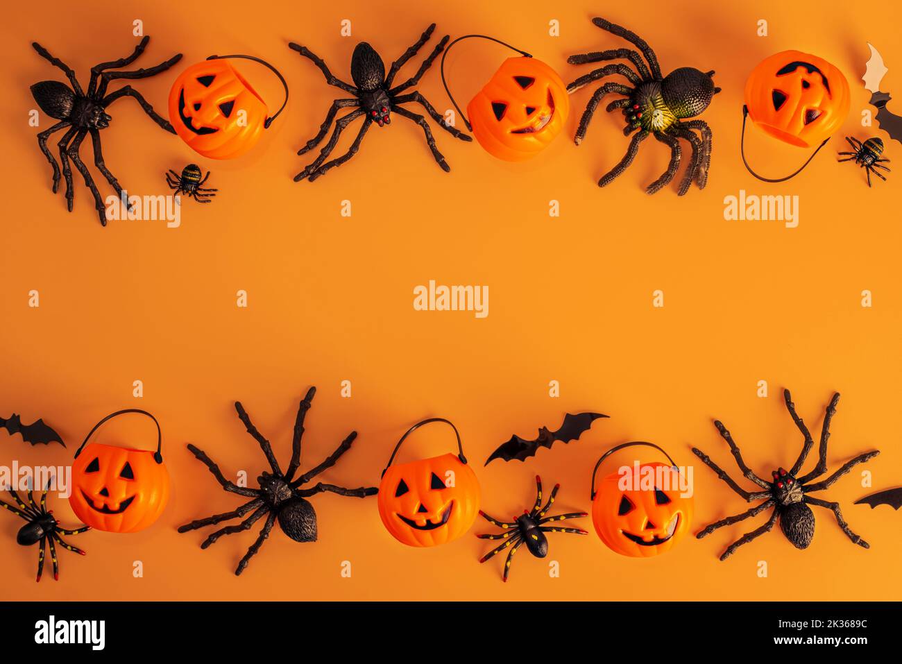 Halloween decorations, pumpkins, bats, spiders on orange background ...