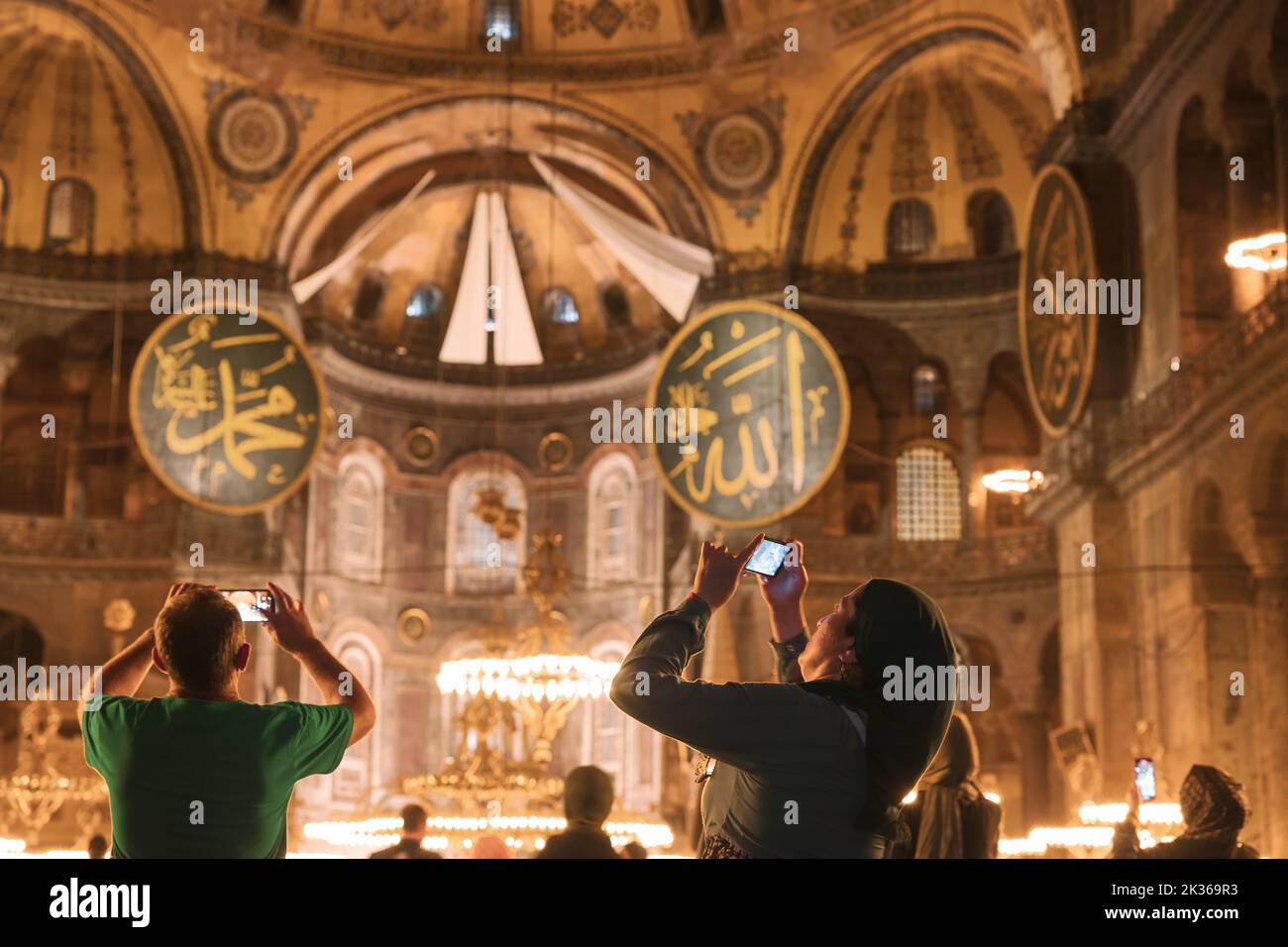 Travel to Istanbul. Tourists taking pictures of Hagia Sophia. Selective focus. Istanbul Turkey ...