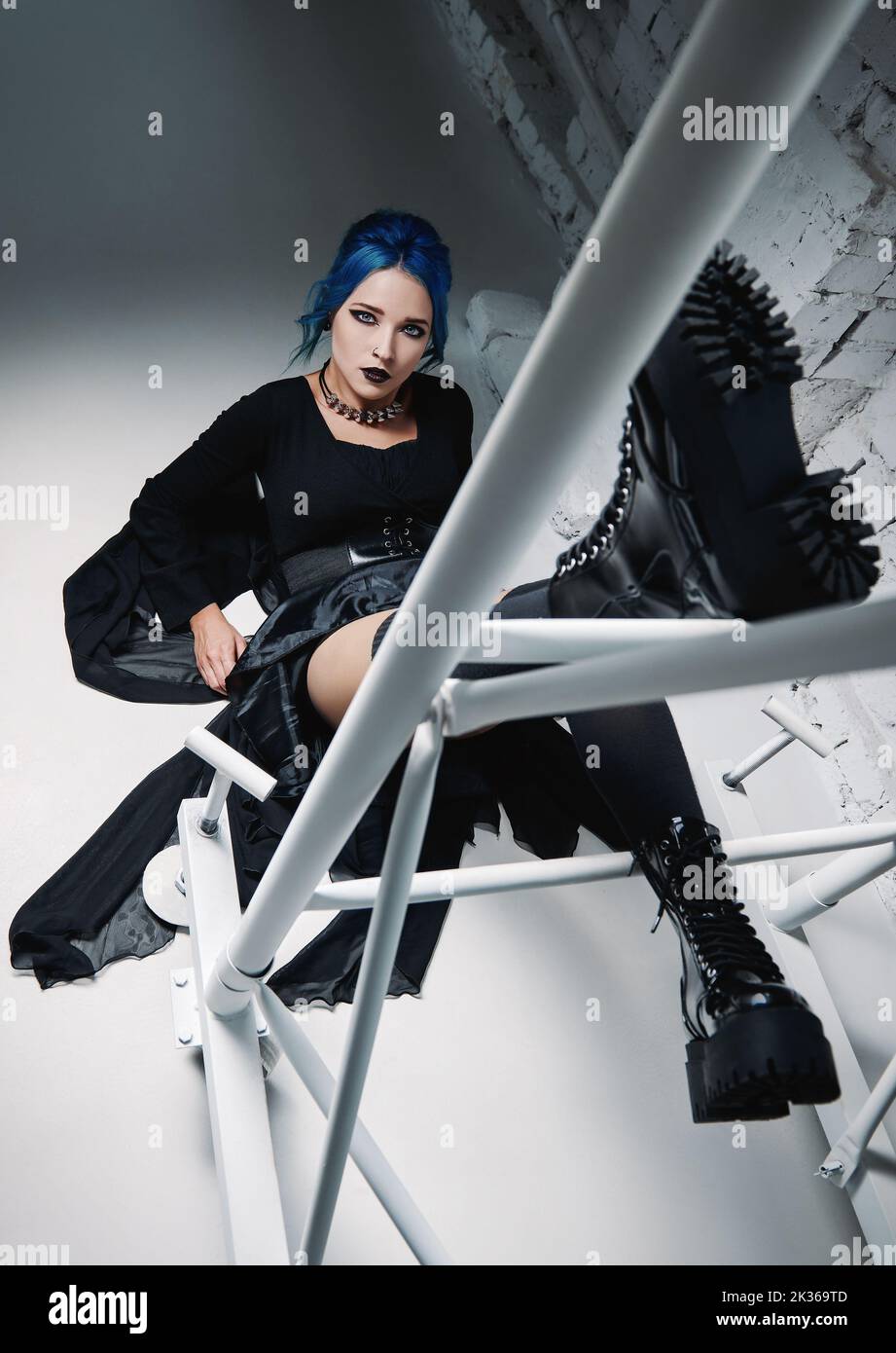 Gothic fashion: beautiful goth girl in black dress and boots lying on ...