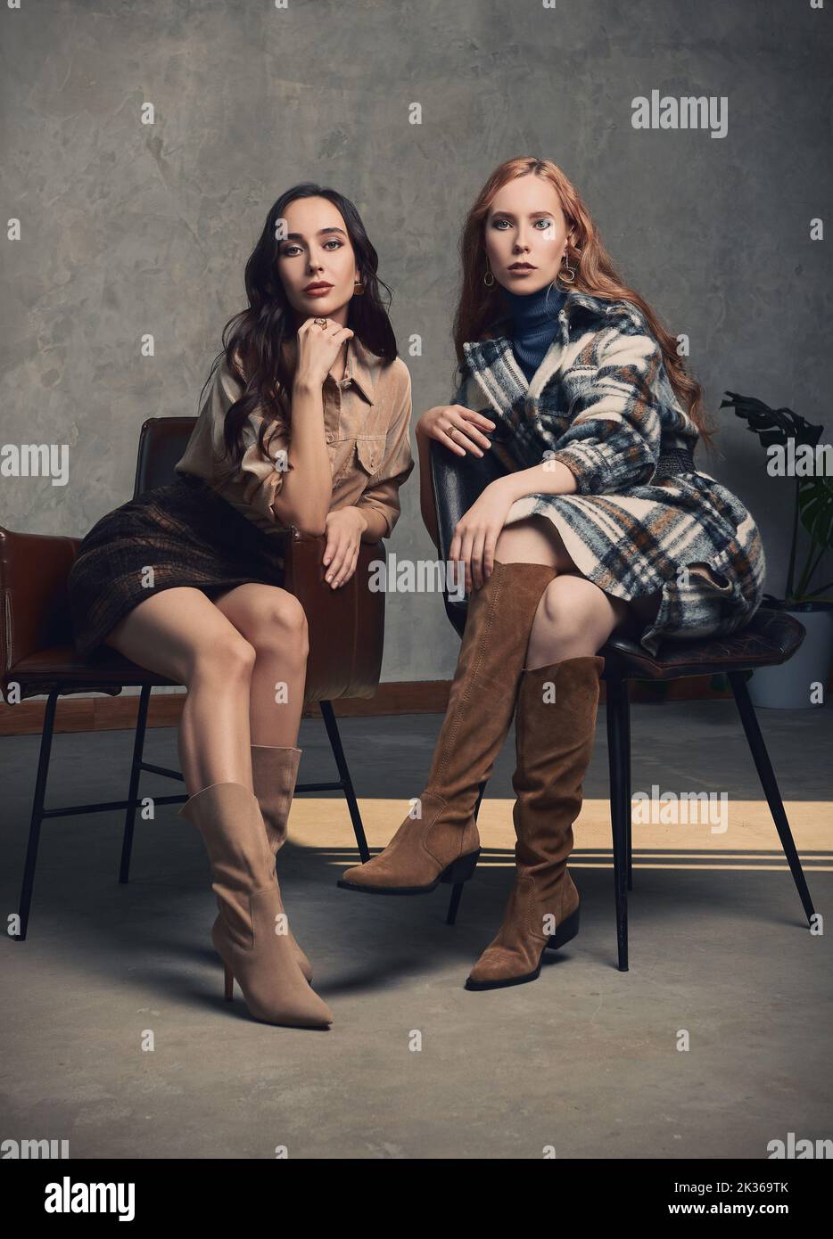 Retro fashion: two beautiful young women sit on chairs. Vintage ...