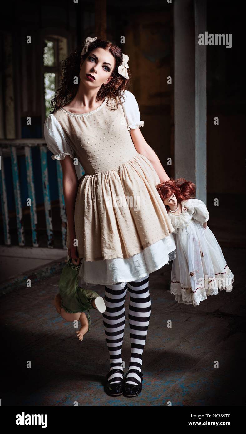 Sad weird girl with dolls in the abandoned place Stock Photo - Alamy