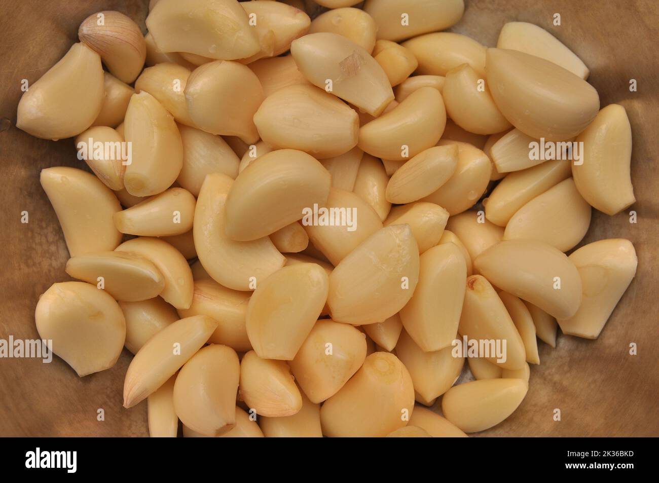 Sliced garlic background, closeup of peeled garlic on aluminum bowl ...