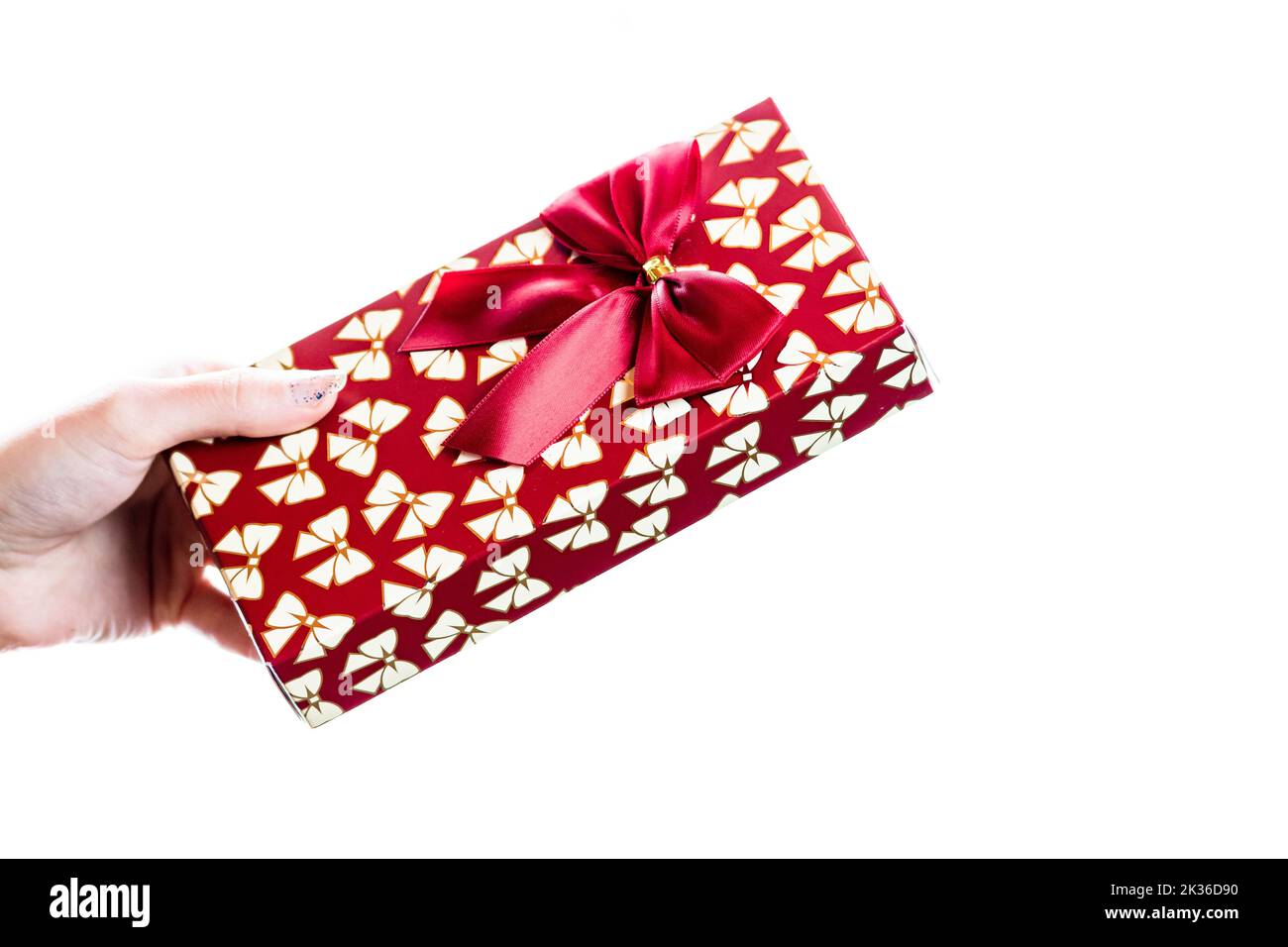 A human hand showing, holding, giving or receiving gift box with red ...