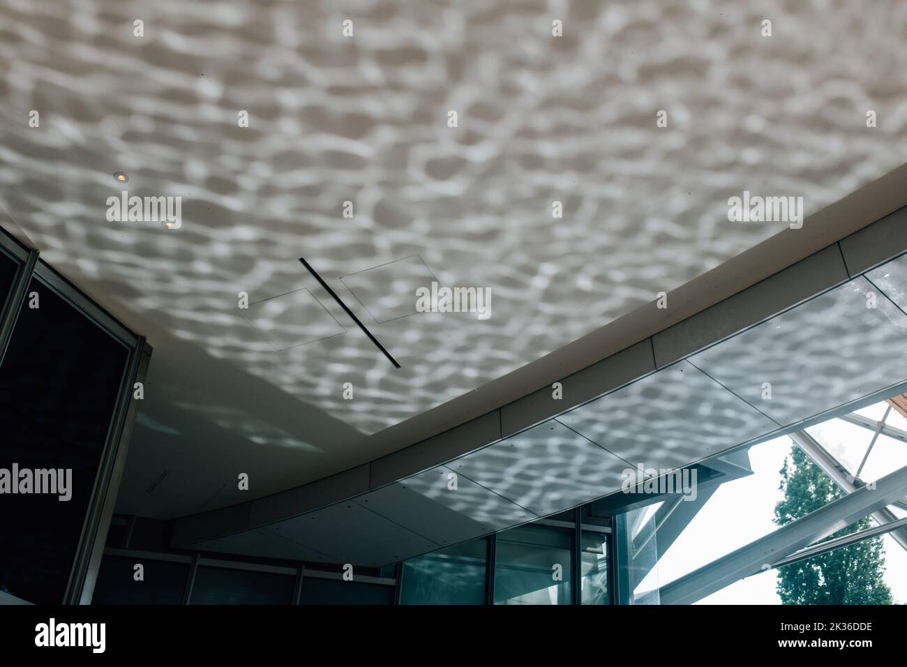 A vertical of an interior of a modern beige building with a windows ...