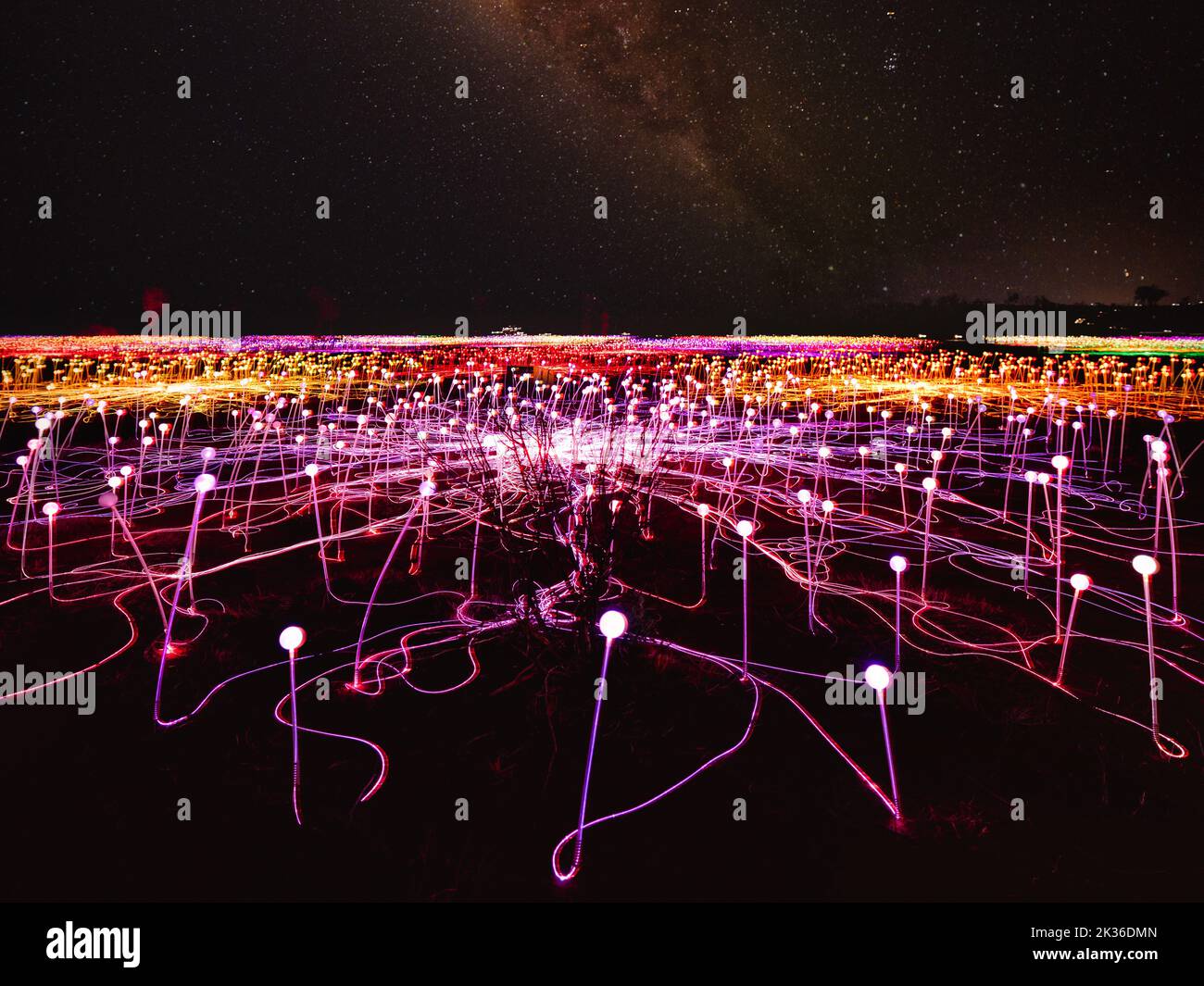 A field of light Uluru under a starry sky in Yulara, Australia Stock ...