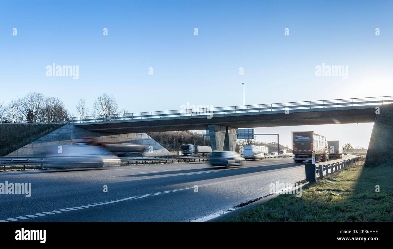 A long highway with passing cars under a blue sky in Denmark Stock ...
