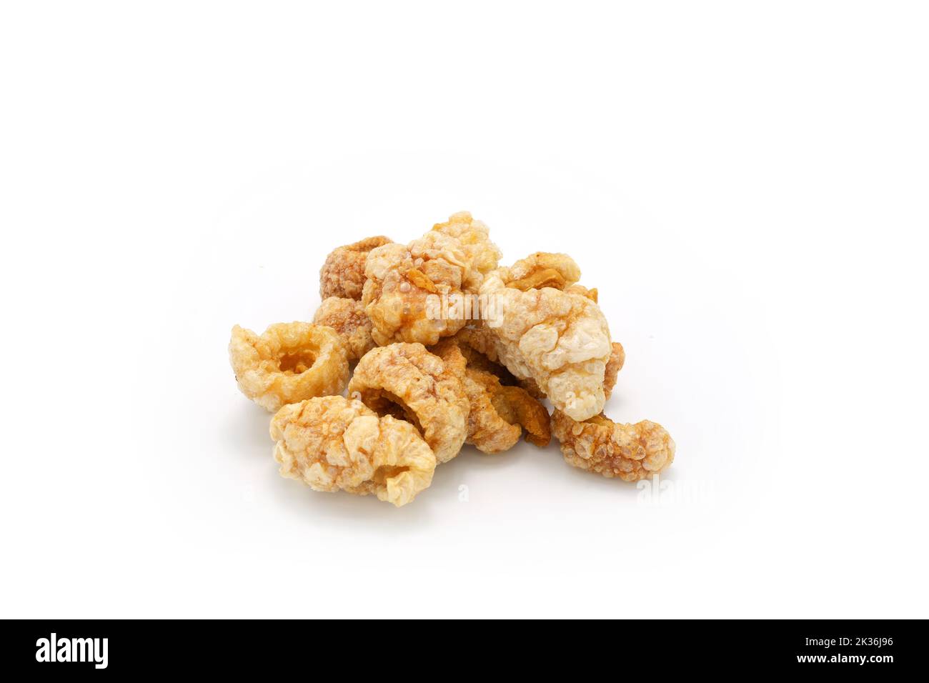 A closeup of deep fried pig skin on a white background Stock Photo - Alamy