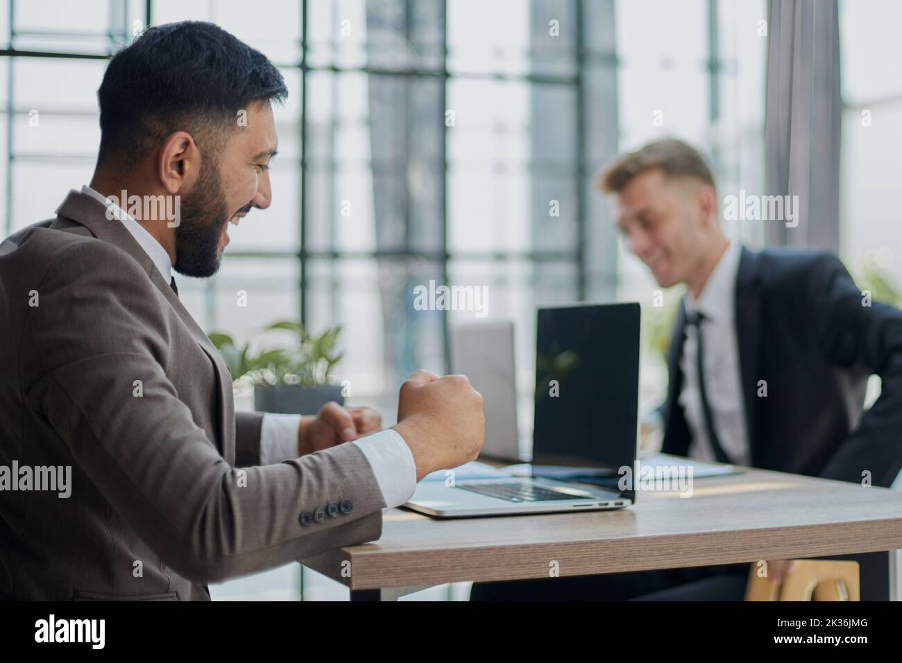 Two happy men working together on a new business project Stock Photo ...