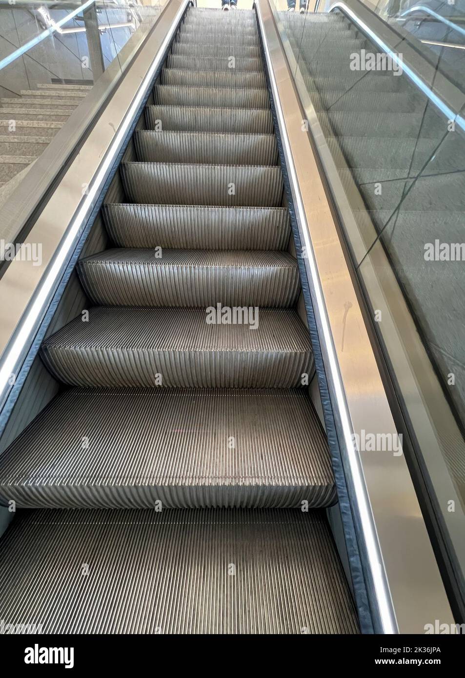 Vertical closeup on an upward pedestrian electric aluminum slow moving ...