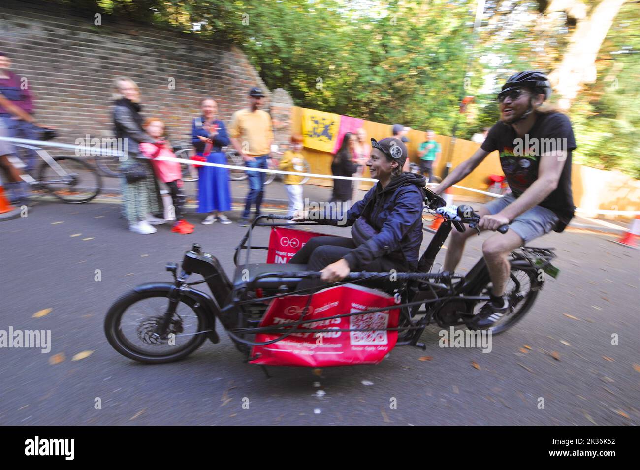 Charlie Fox (rider No. 357) riding a cargo bike, racing up Swains Lane ...