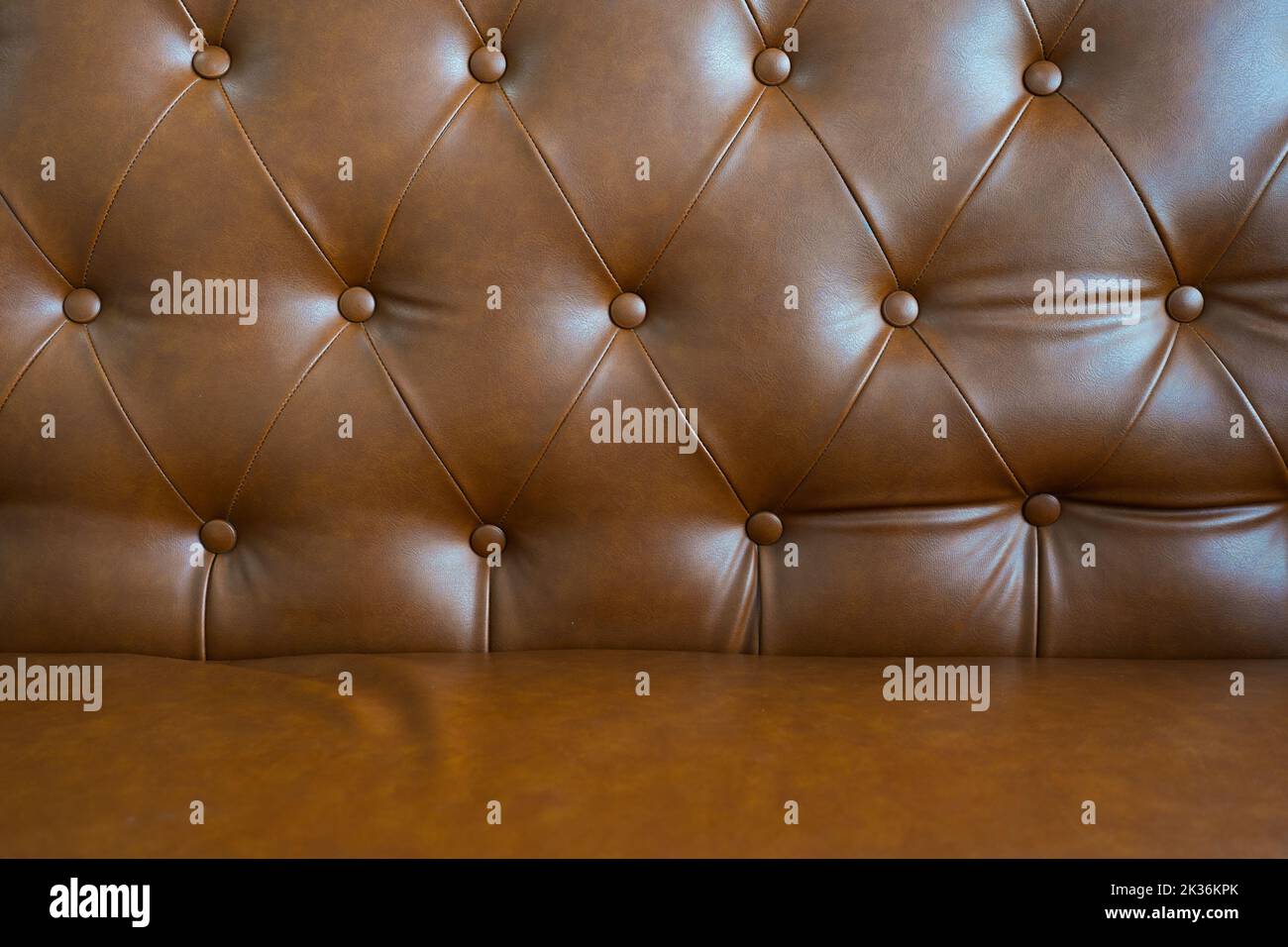 A brown leather sofa texture with buttons Stock Photo - Alamy