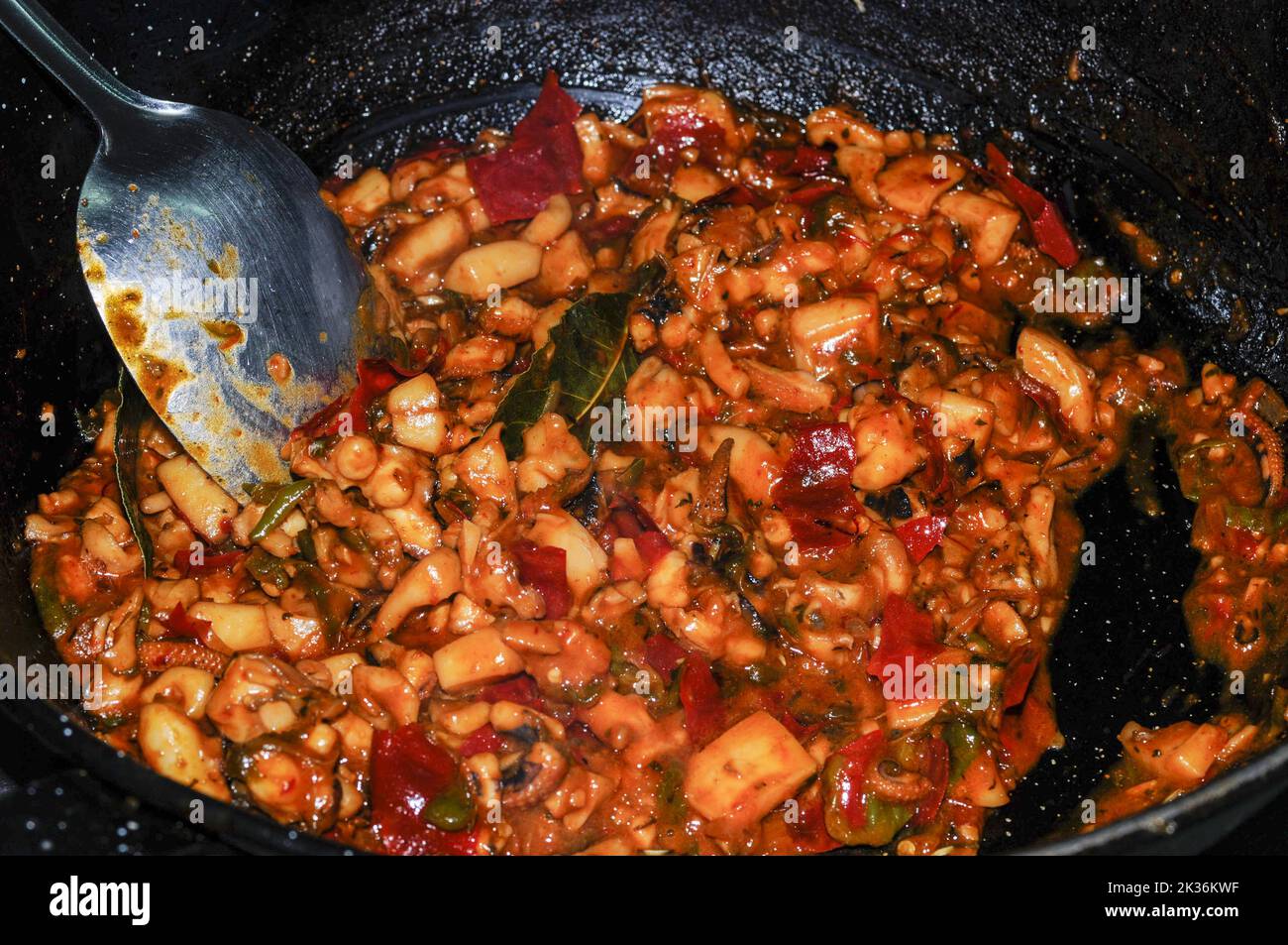 Cooking cuttlefish in American sauce on the stove of a kitchen Stock ...