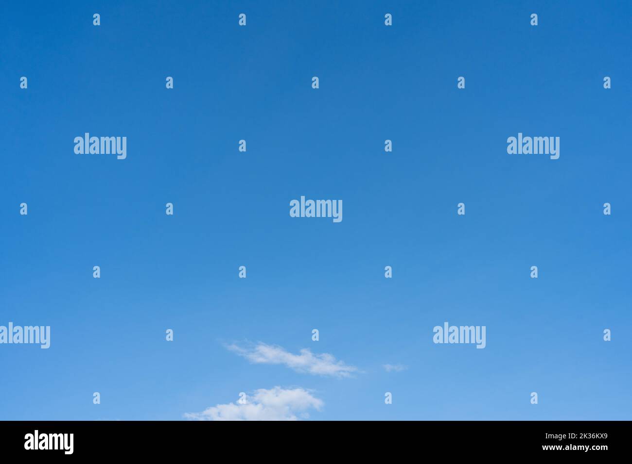 A blue sky with some clouds background Stock Photo - Alamy