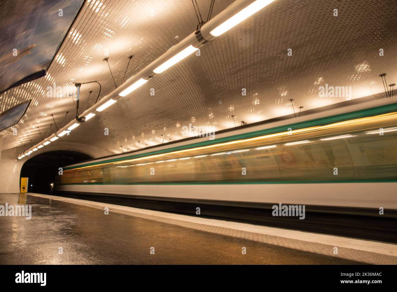 Paris, France. August 2022. A subway station with a passing train in ...
