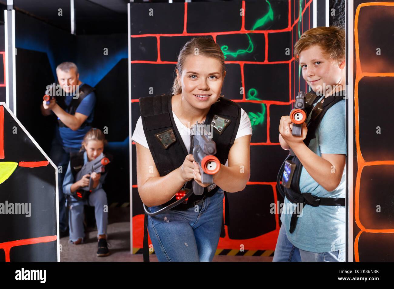 Mother and son with laser pistols playing laser tag Stock Photo - Alamy