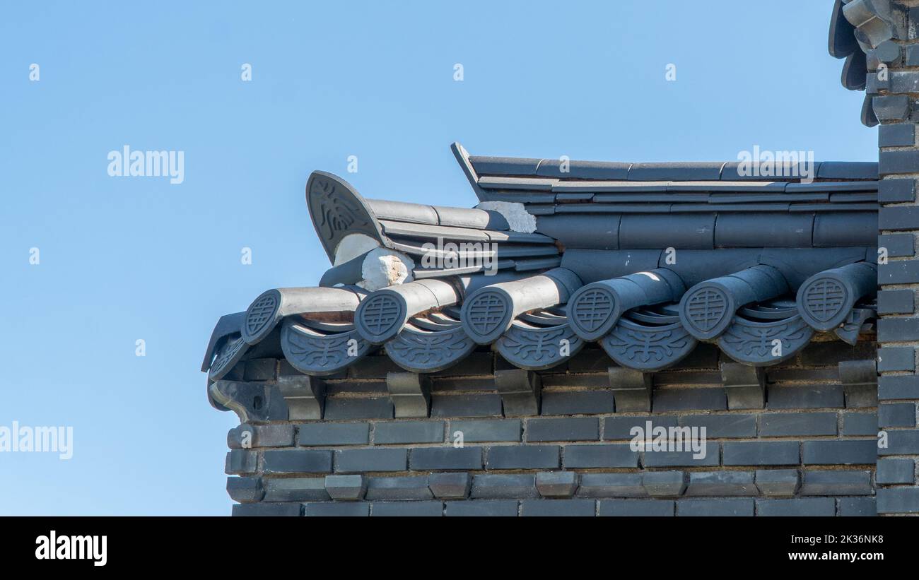 Part of the roof in the oriental style, tiles and brickwork, background ...