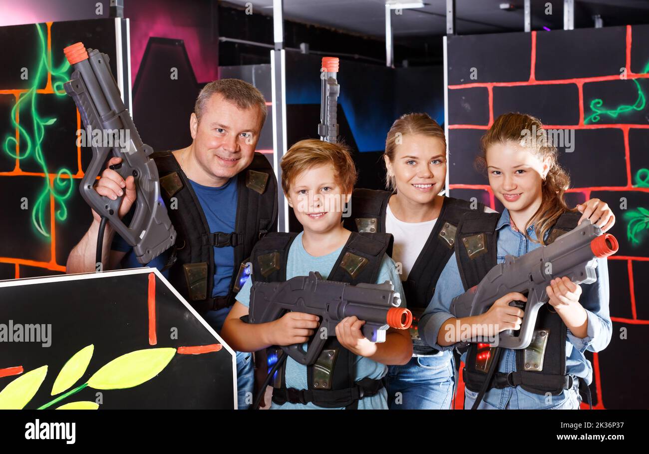 Parents and children with laser pistols Stock Photo - Alamy