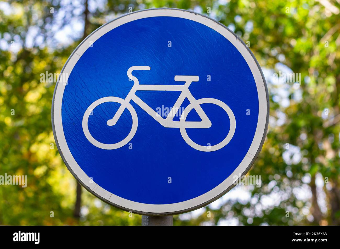 Blue and white bicycle lane sign indicating bike route, large round ...