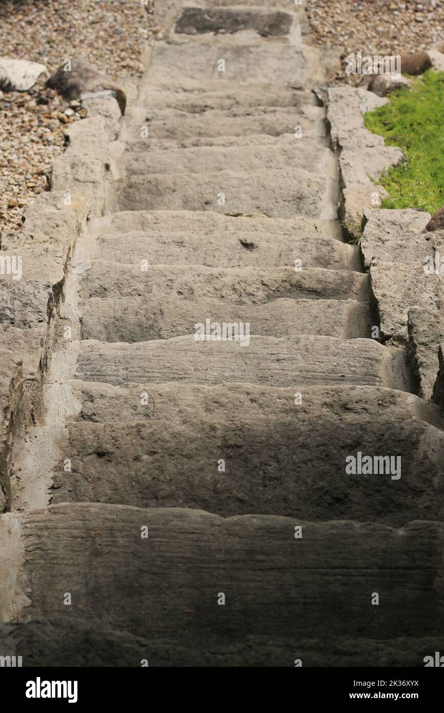 Ancient uneven stone stairs with weathered steps Stock Photo - Alamy