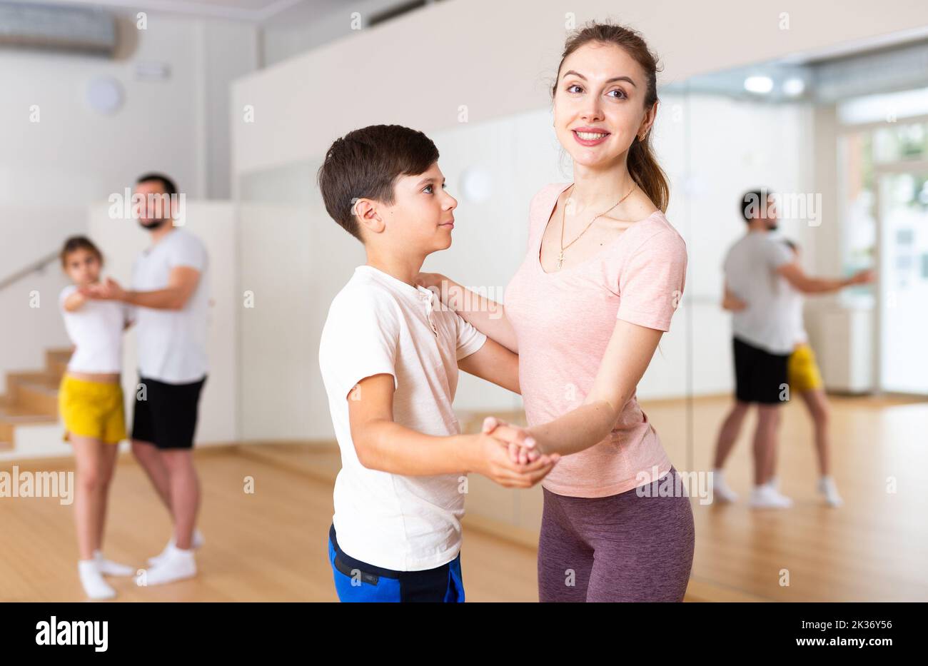 Family practicing active dance in pairs Stock Photo - Alamy