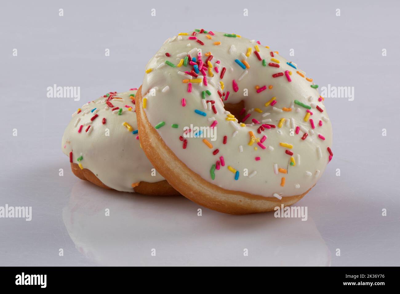 Traditional American donuts with chocolate and pink icing and sprinkles ...