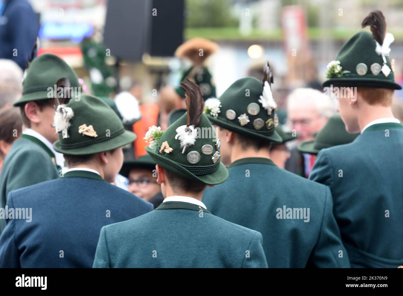 25 September 2022, Bavaria, Munich: Men in traditional costume hats ...